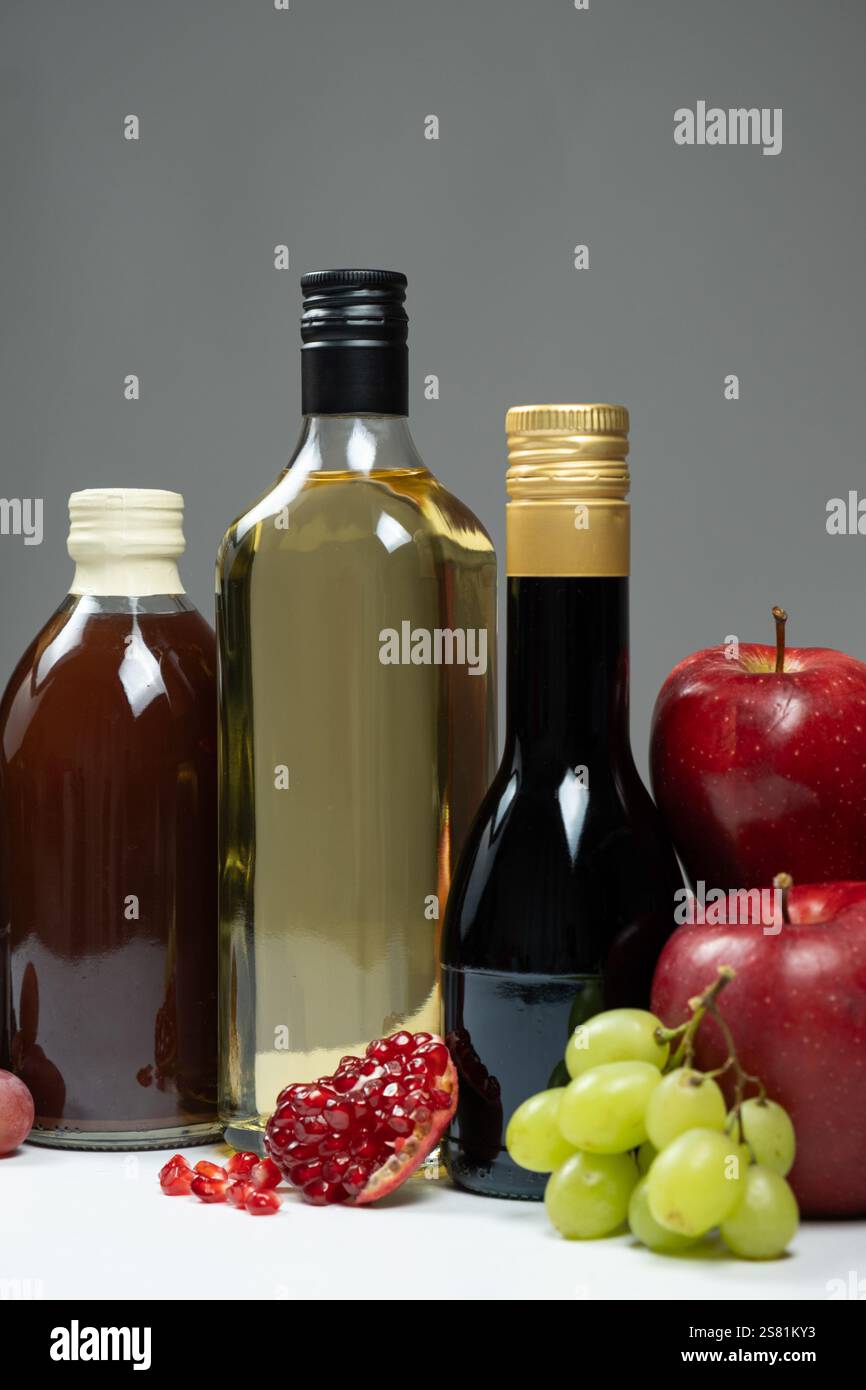 Different types of vinegar. Pomegranate, apple and balsamic vinegars in ...