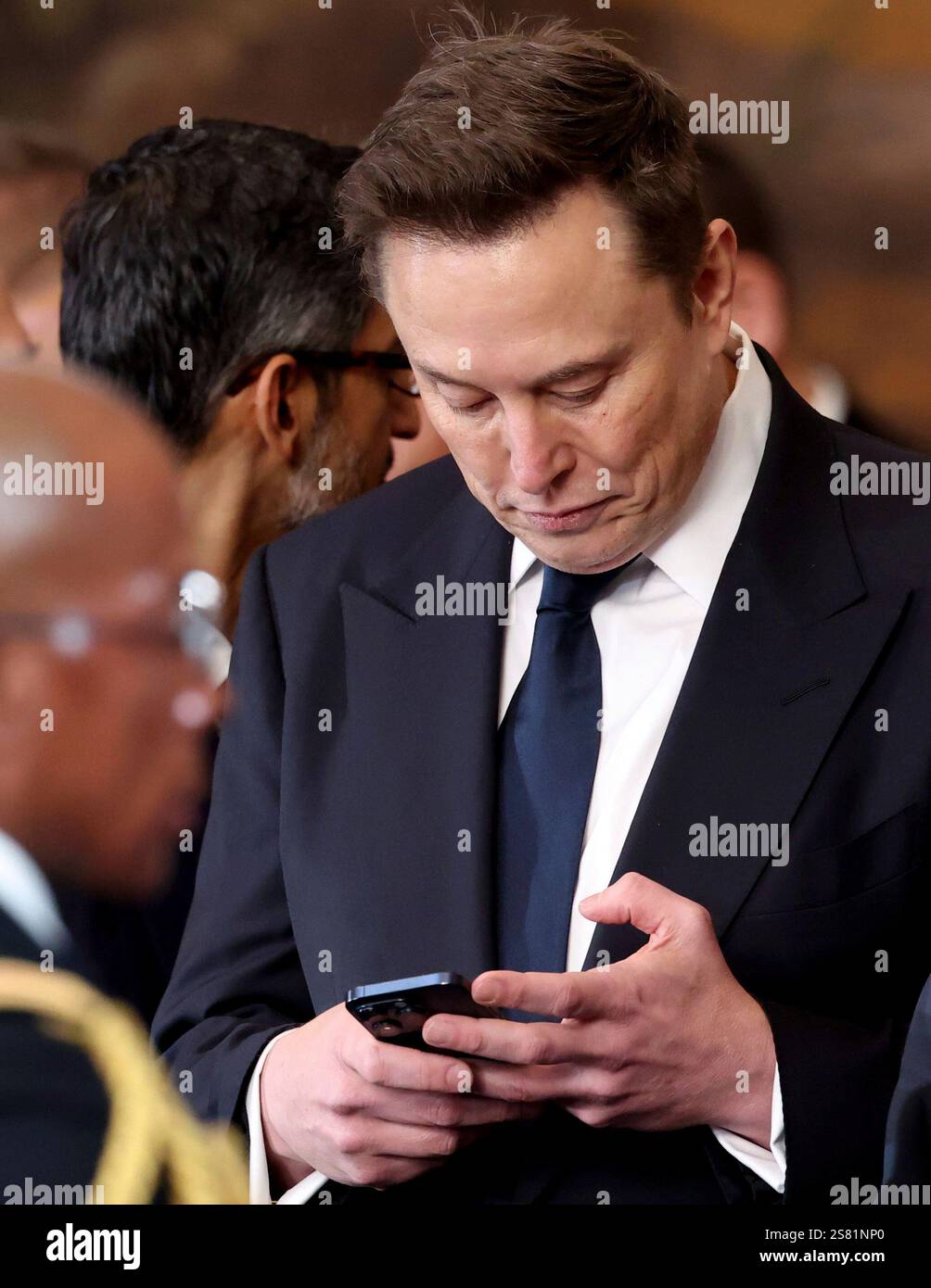 Elon Musk uses his cell phone after the 60th Presidential Inauguration ...