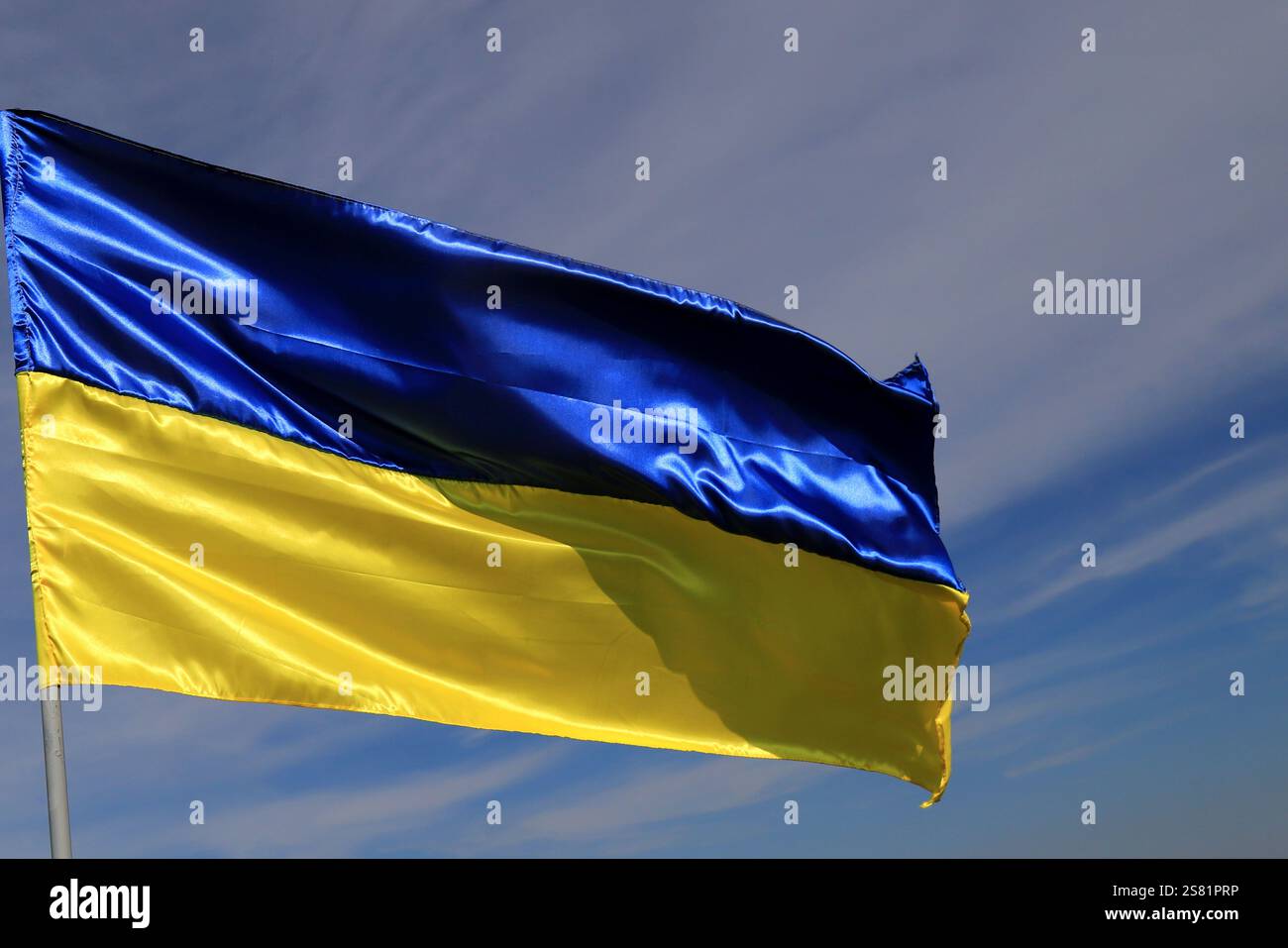 Ukraine flag large national symbol fluttering in blue sky. Large yellow ...