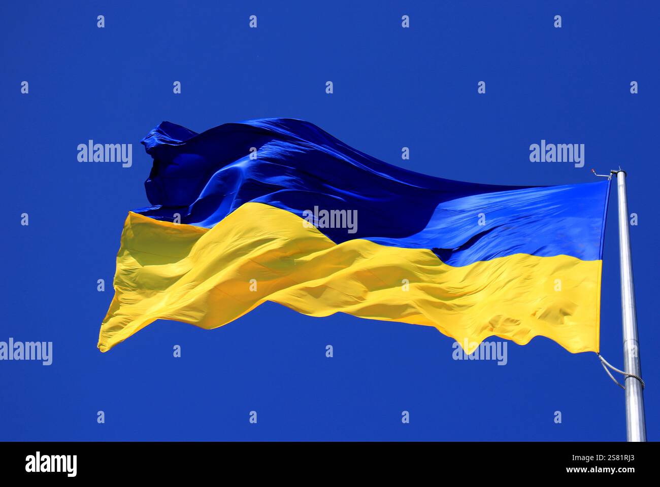 Ukraine flag large national symbol fluttering in blue sky. Large yellow ...