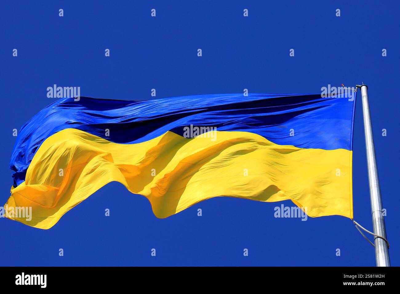 Ukraine flag large national symbol fluttering in blue sky. Large yellow ...