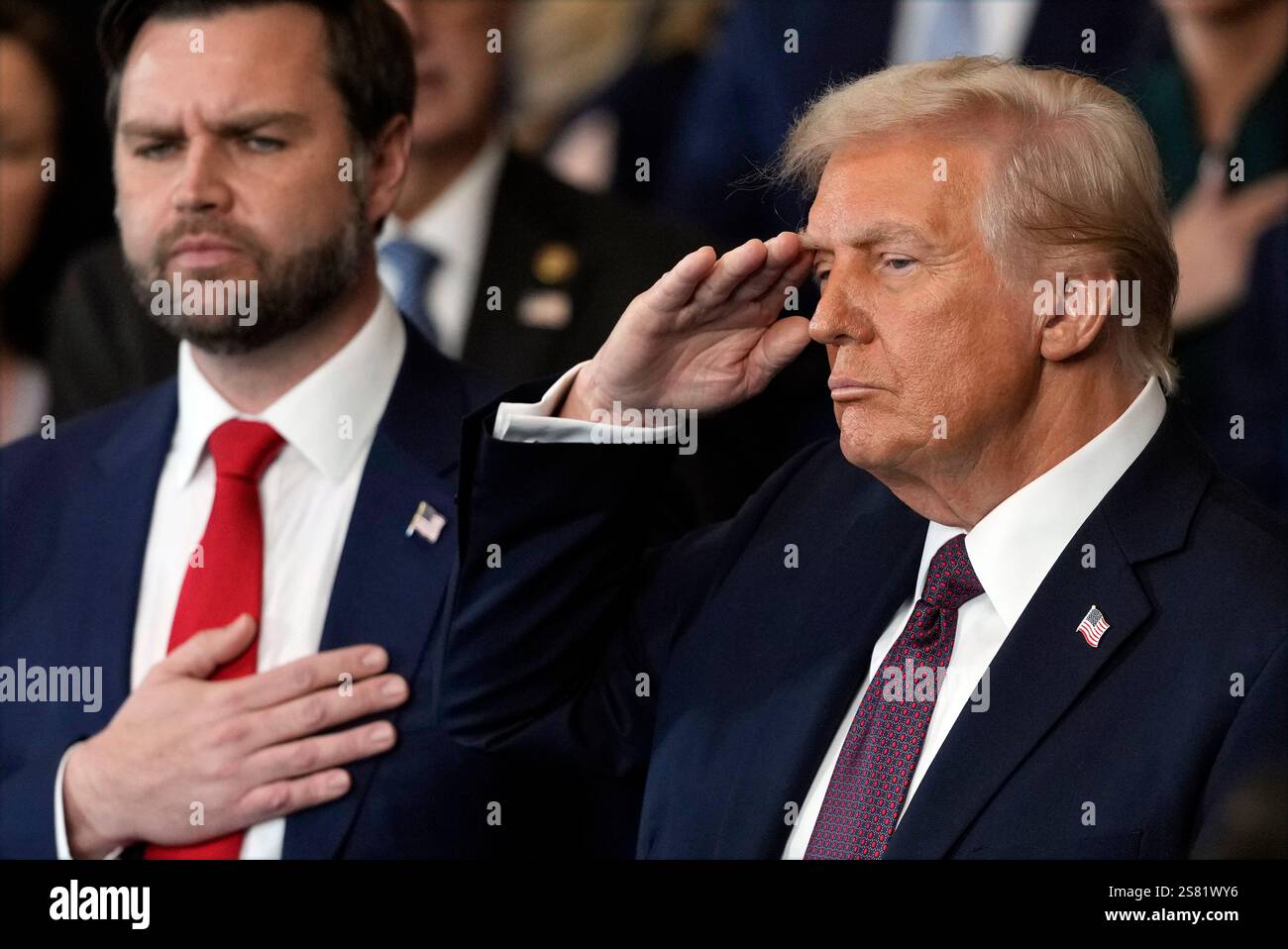 President Donald Trump and Vice President JD Vance listen to ...