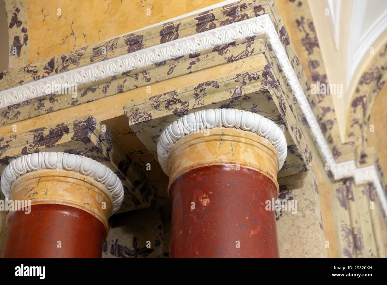 Stone pillars with stone capitals are under ceiling, classic ...