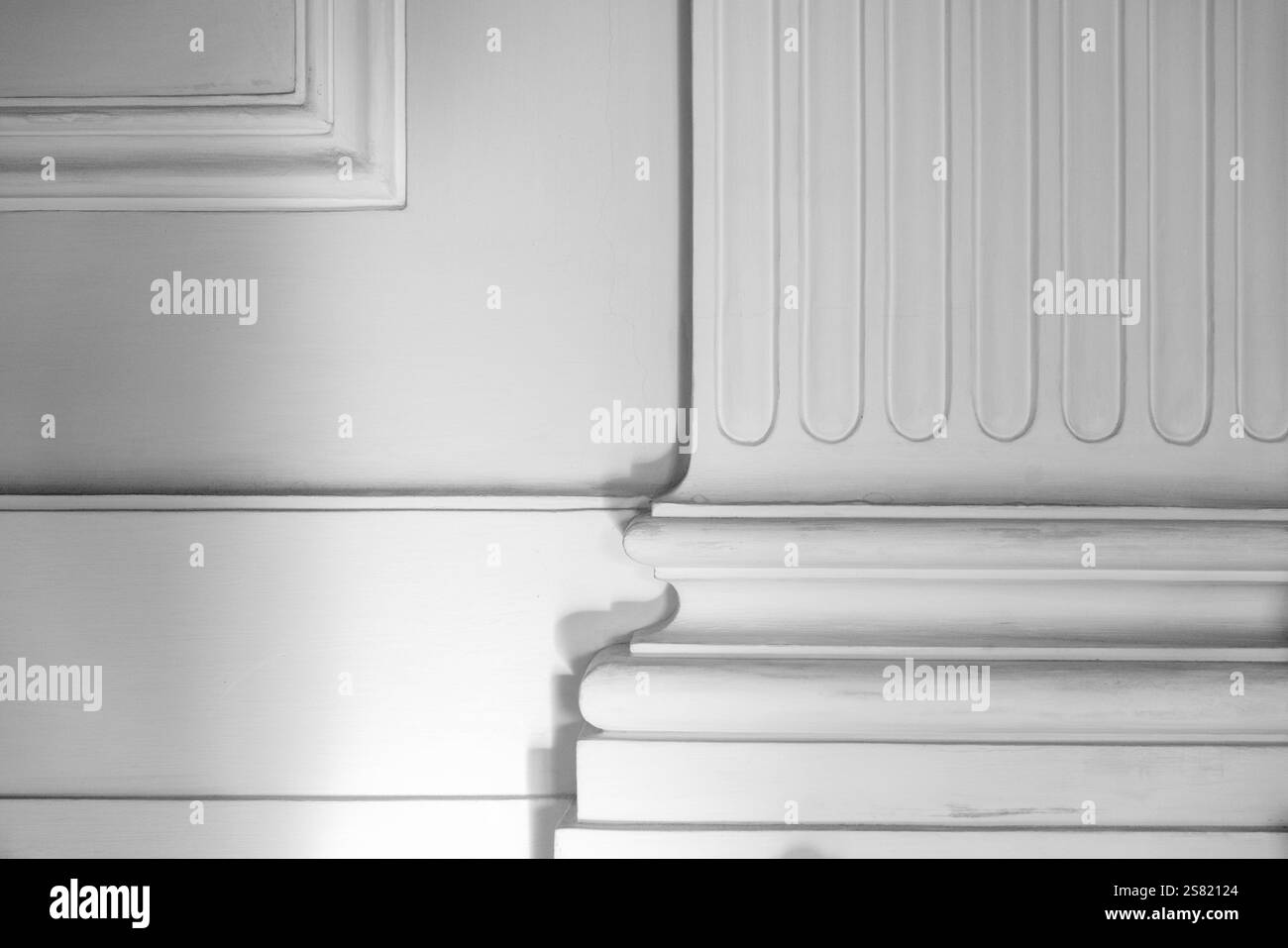 Classic interior fragment, decorative pillar base with white marble ...