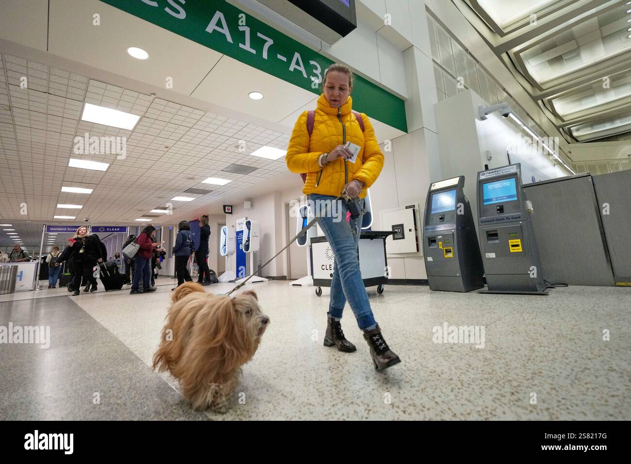 Laura Voros walks her dog, Mia, through George Bush Intercontinental ...
