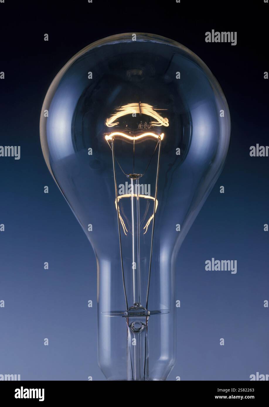 Incandescent light bulb showing glowing tungsten filament Stock Photo ...