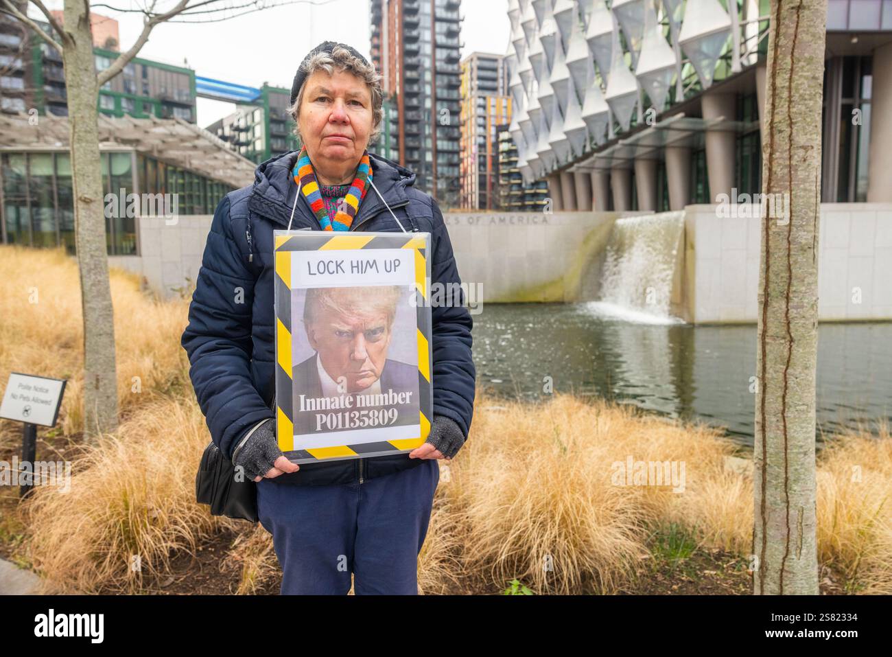 London, UK. 20 JAN, 2025. Women holds a "Lock him up" mugshot of Trump ...