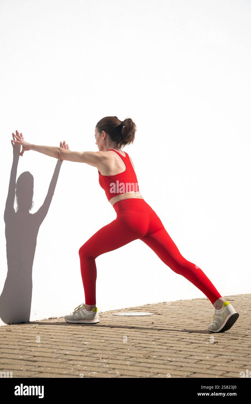 Woman performing lunge stretch hi-res stock photography and images - Alamy