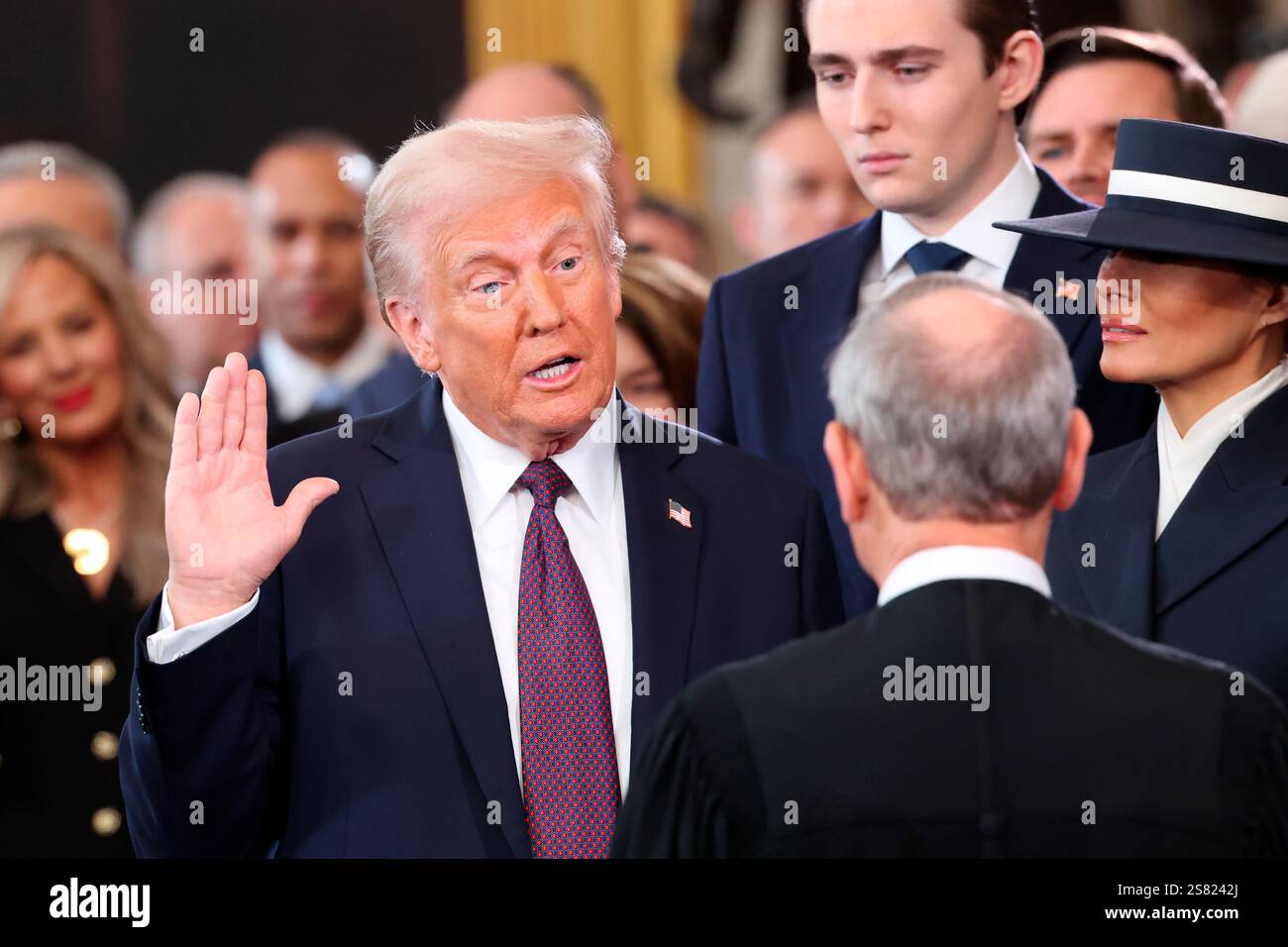 U.S. President Donald Trump takes oath as Barron Trump and Melania ...