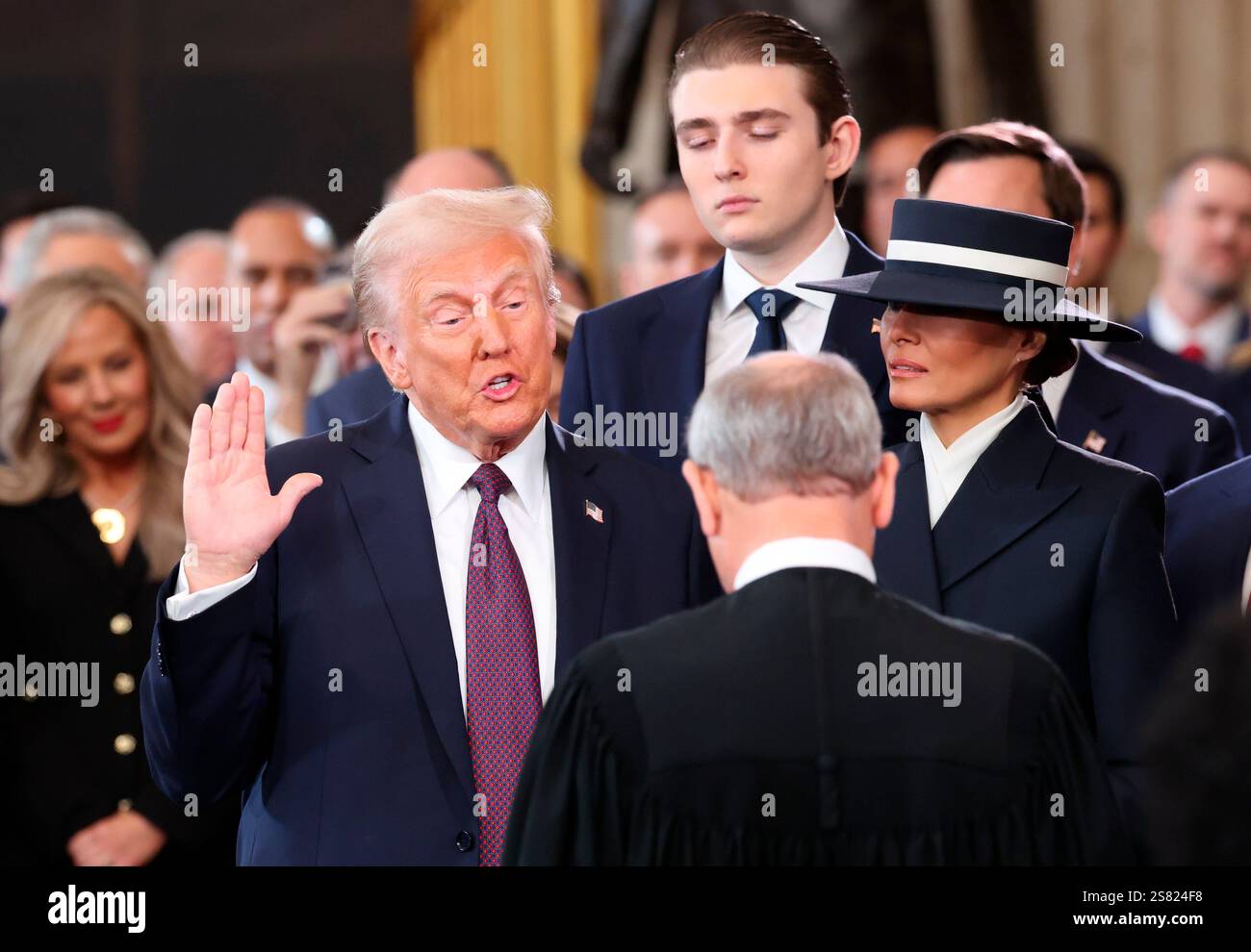 U.S. President Donald Trump takes oath as Barron Trump and Melania ...