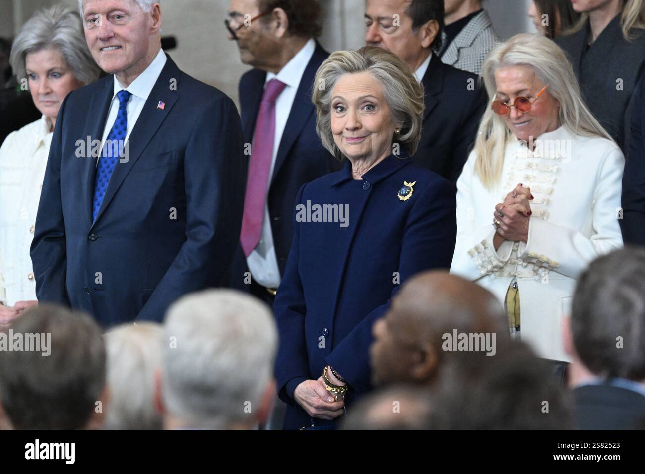 Former US Secretary of State Hillary Clinton (C) stands next to Miriam ...