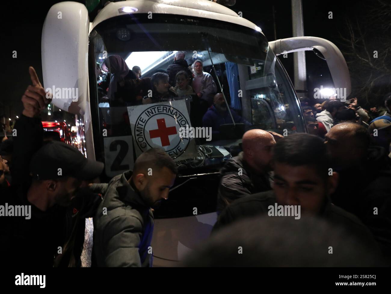 Ramallah. 19th Jan, 2025. People gather around a bus carrying released ...
