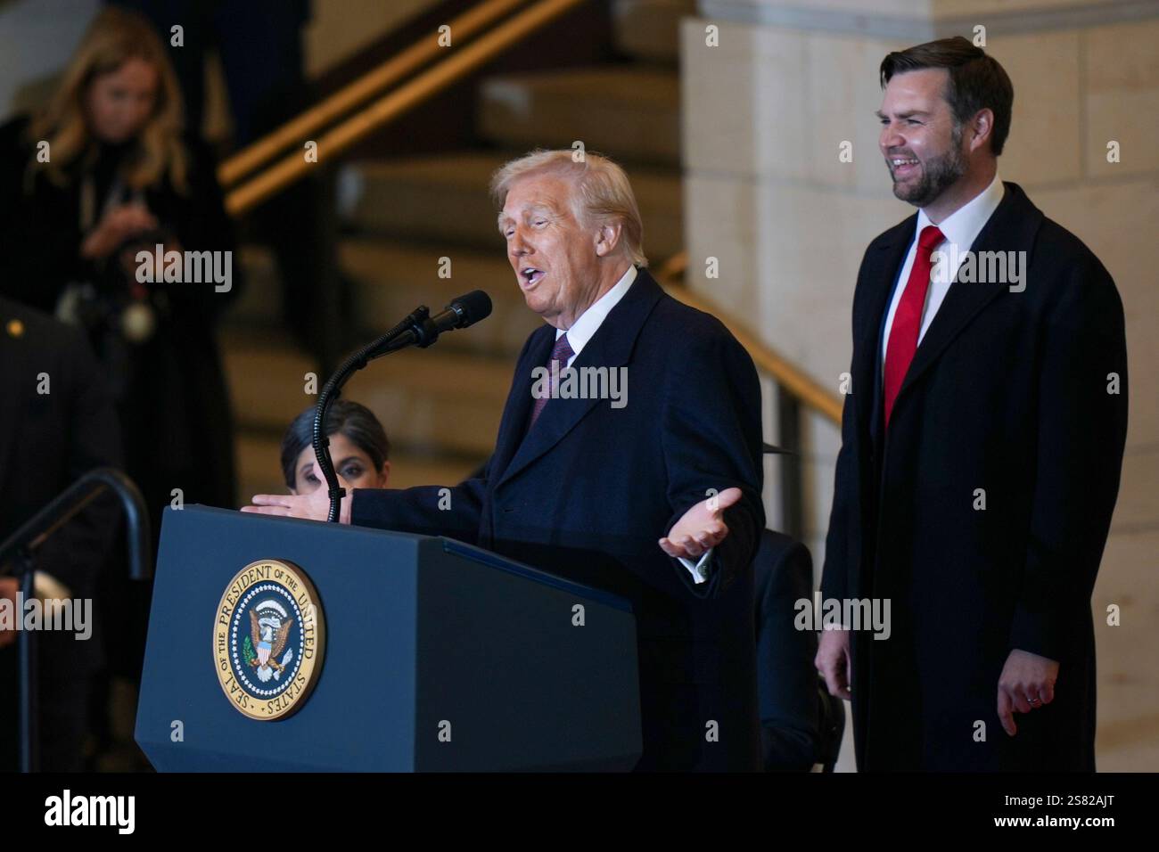 President Donald Trump speaks as Vice President JD Vance watches at ...