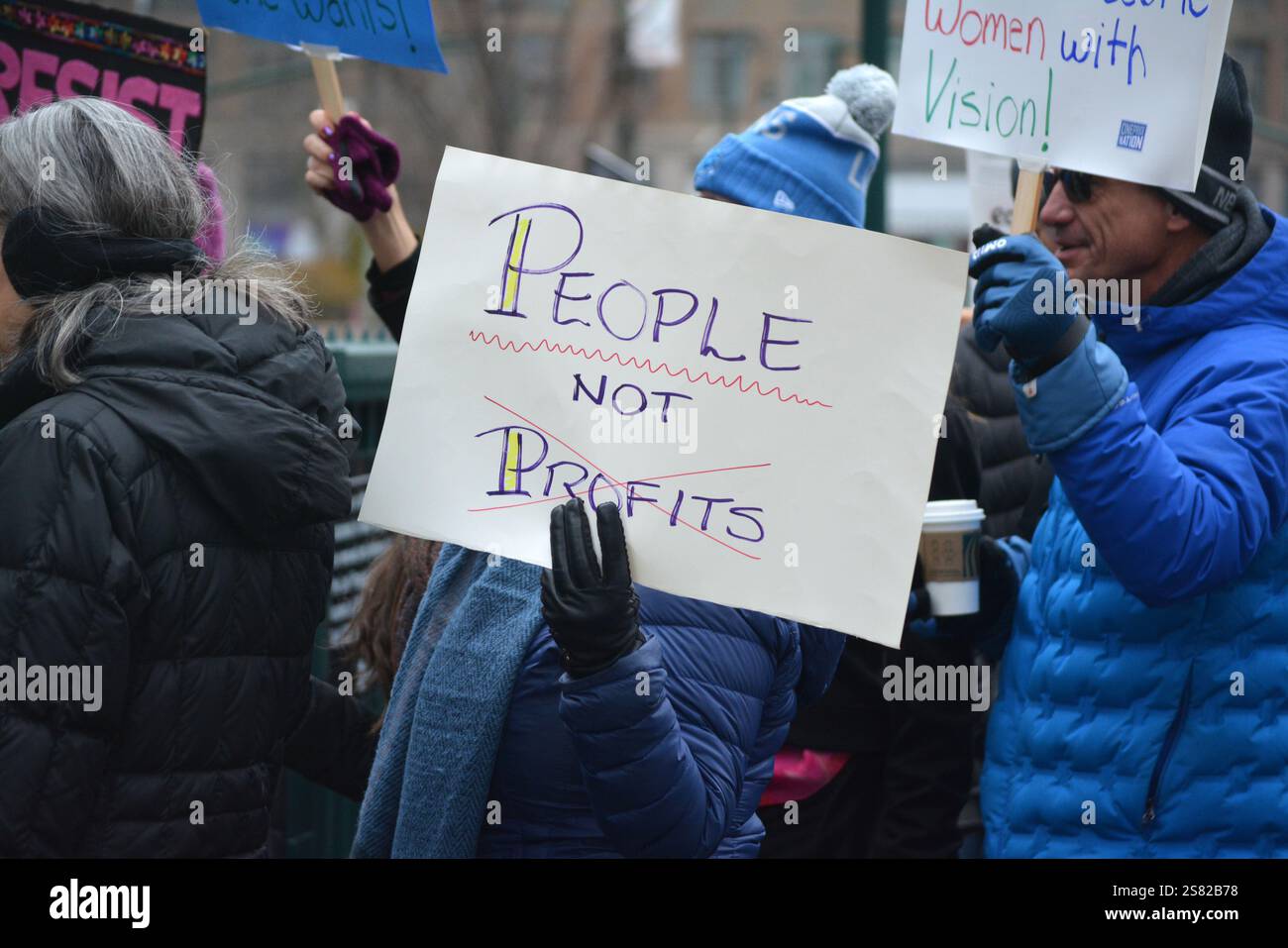 People with signs during the 2025 People's March against the incoming ...