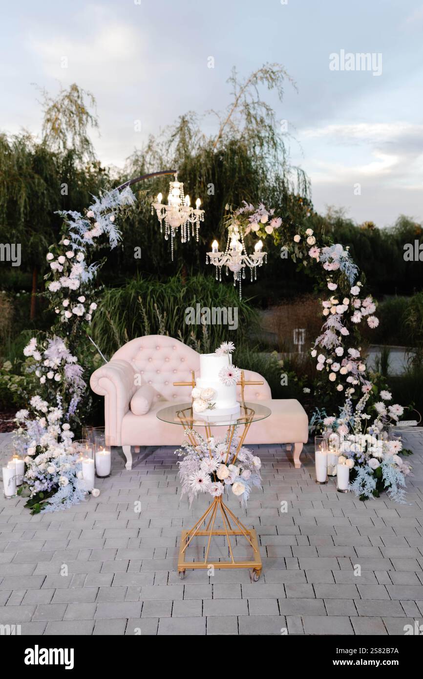 Luxurious wedding setup featuring a beige chaise lounge beneath a ...