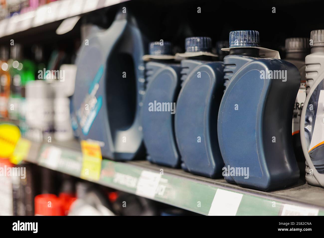 Plastic bottles with motor oil on the supermarket shelf Stock Photo - Alamy