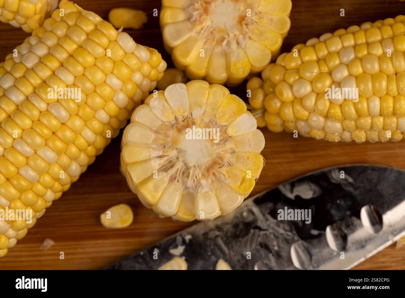 sliced peeled corn cob with yellow and white seeds of different sizes ...