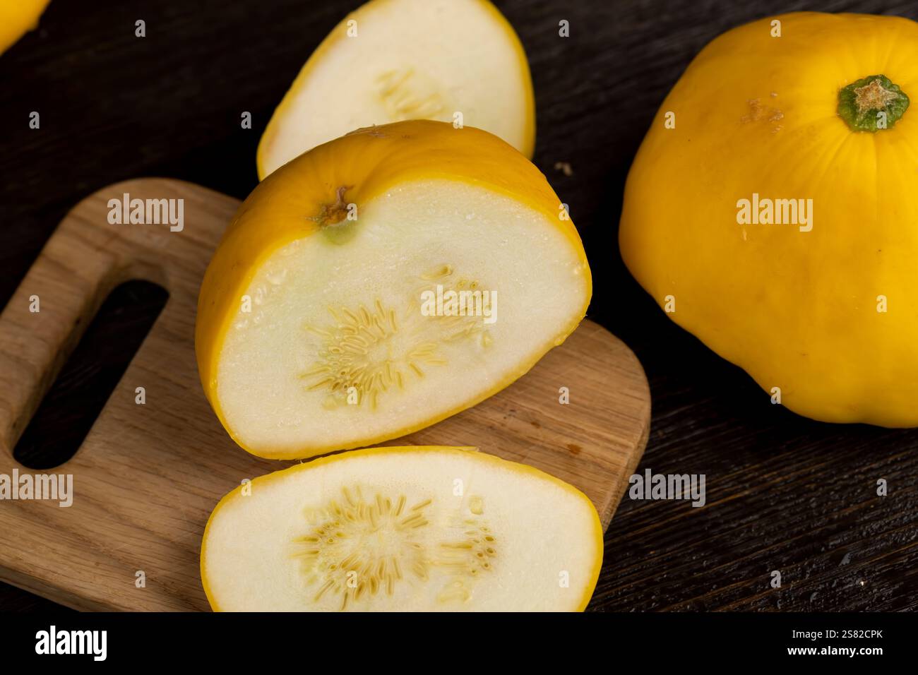 sliced ripe yellow squash on the table, small pieces of delicious ripe ...