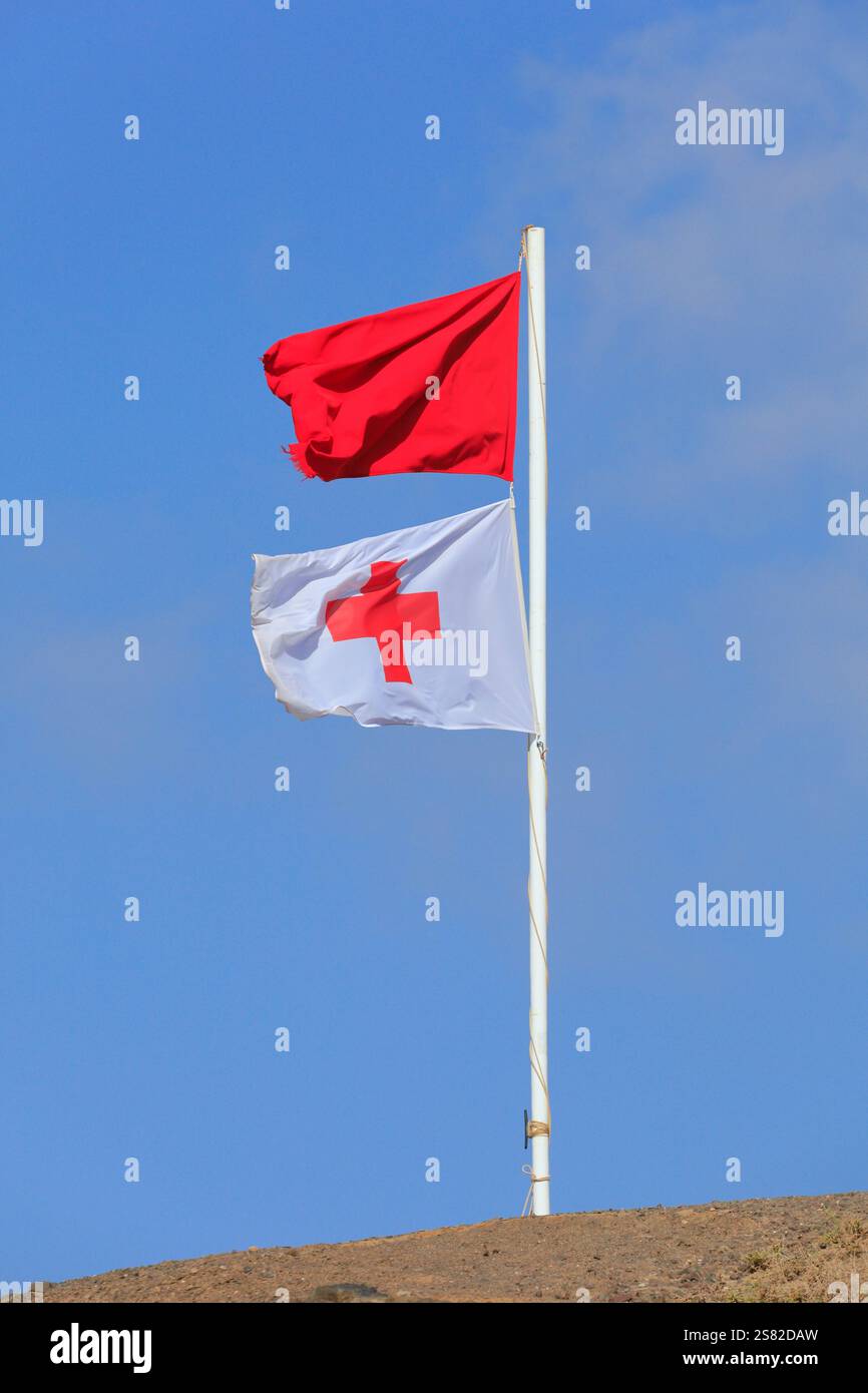 Life guard (cruz roja) flags flying at Piedra Playa beach, El Cotillo ...
