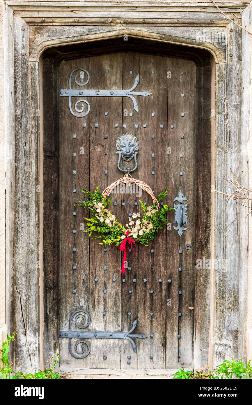 Old Rustic Door with Wrought Iron Elements and Hanging Flowers Stock ...