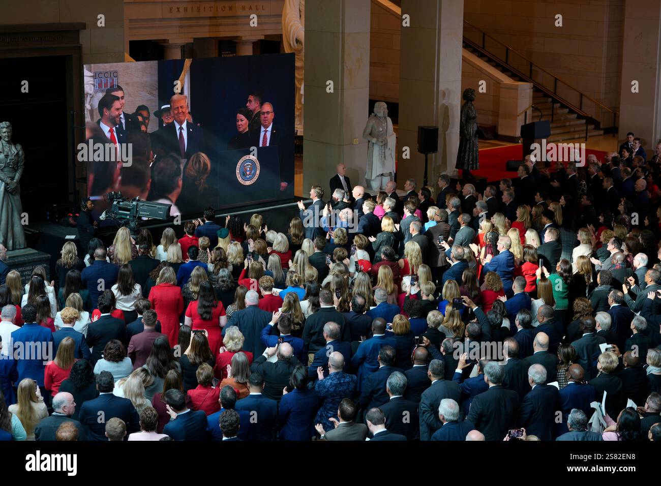 Guests watch from Emancipation Hall as President Donald Trump speaks at ...