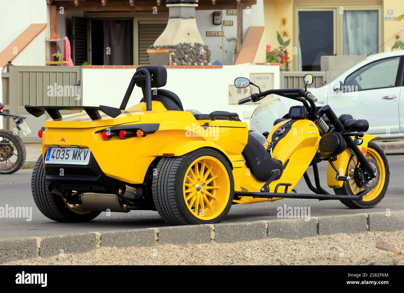 Three wheeler yellow Rewaco motor bike parked by the roadside, El ...