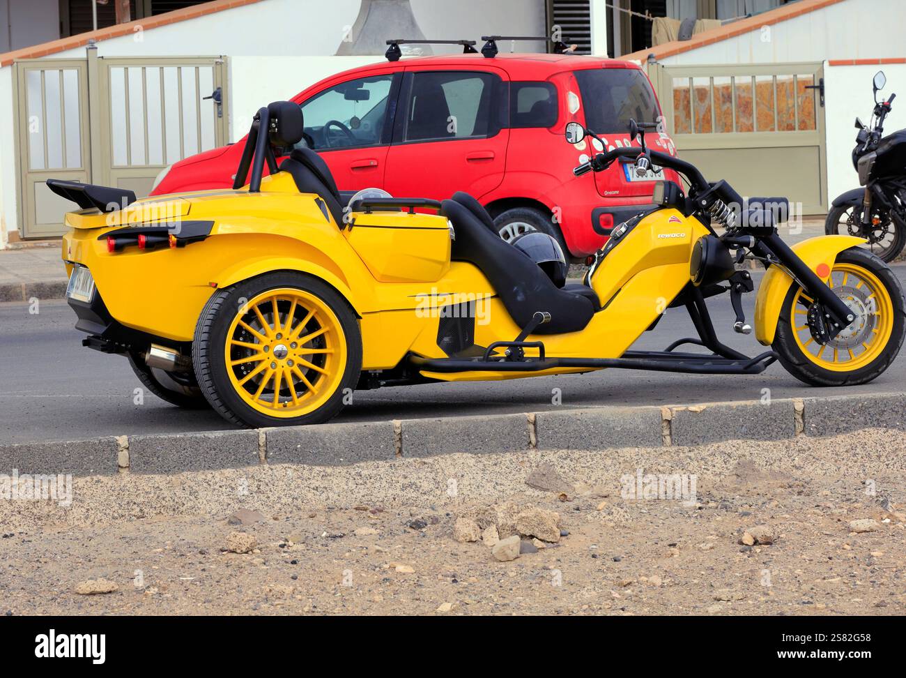 Three wheeler yellow Rewaco motor bike parked by the roadside, El ...