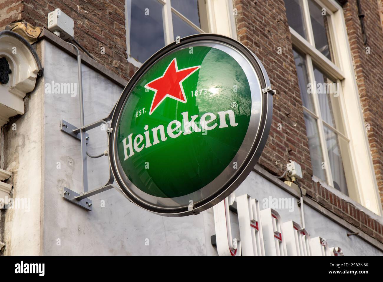 Heineken Flag sign logo against a blue sky. Heineken is a Dutch ...
