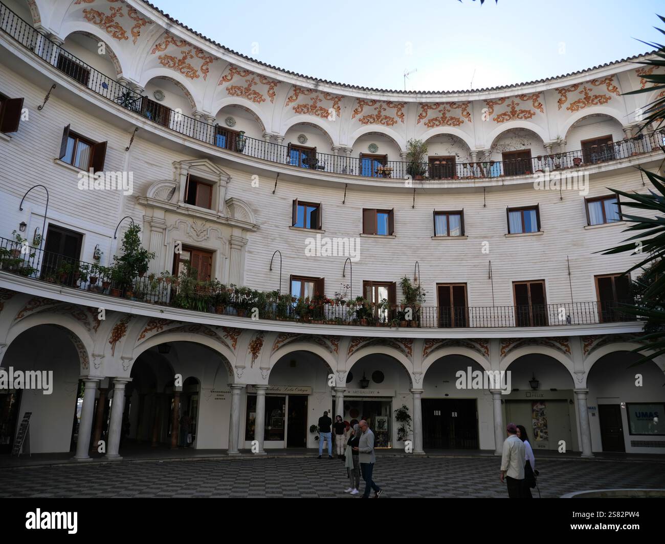 Curved historic house with arcades in Plaza del Cabildo in Seville ...