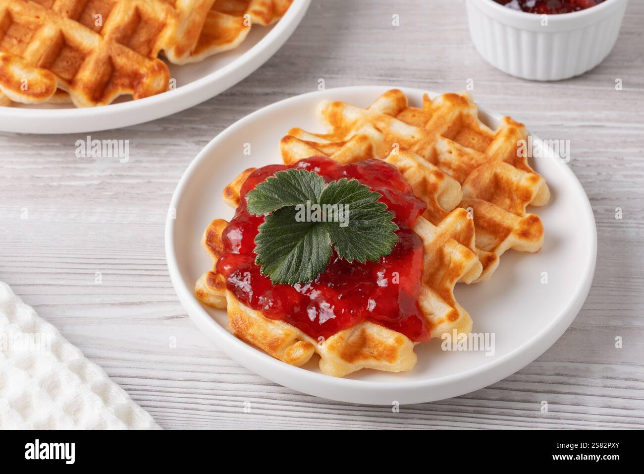 Waffles with strawberry jam for breakfast Stock Photo - Alamy
