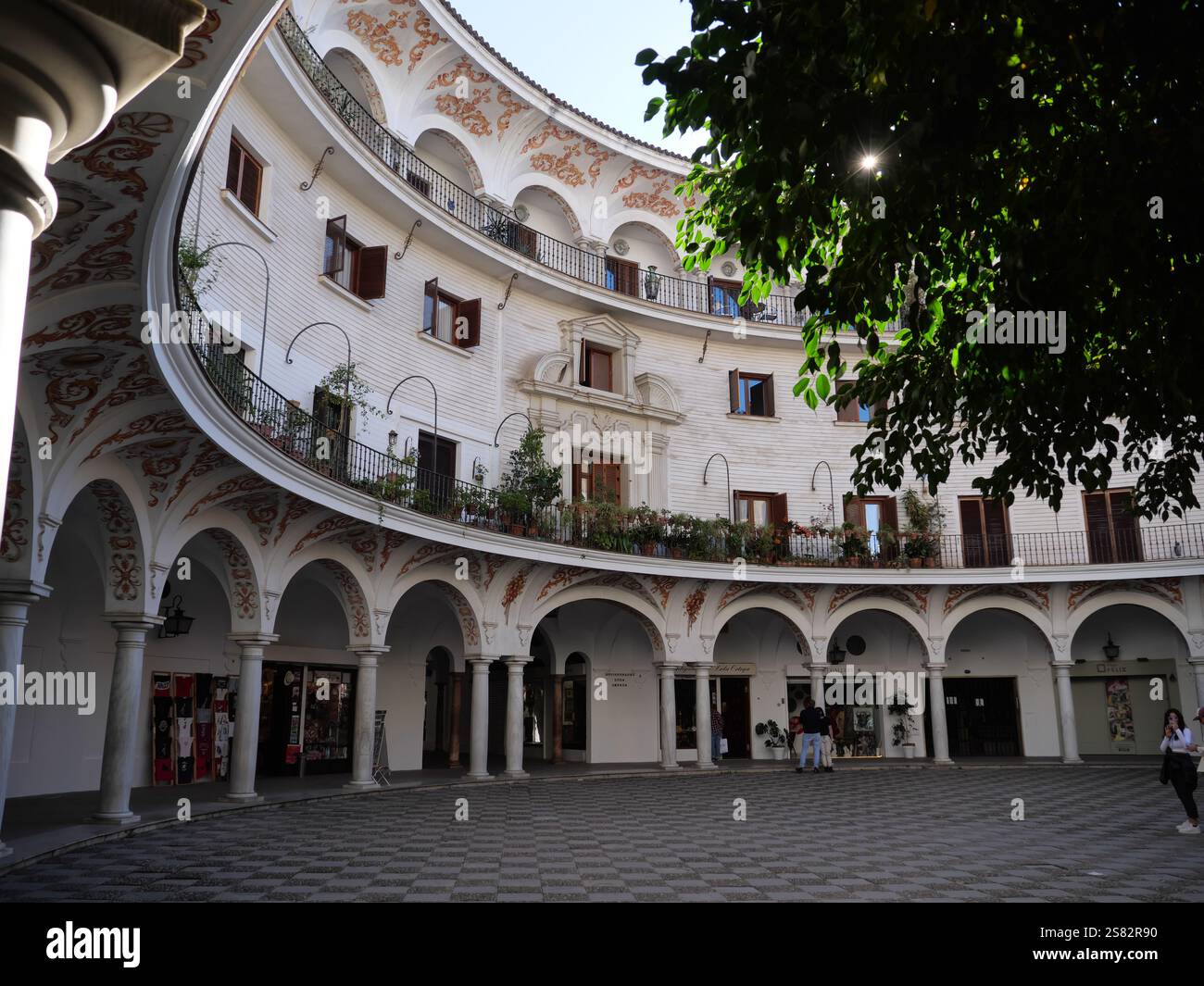 Curved historic house with arcades in Plaza del Cabildo in Seville ...