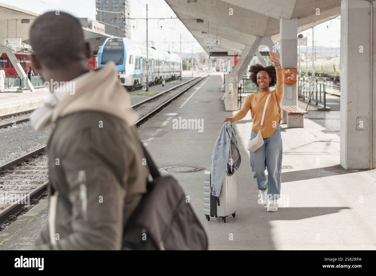 African American couple meeting at a railway station near arrived train ...