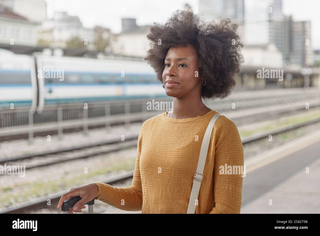 African American woman waiting for a train on a railway station ...