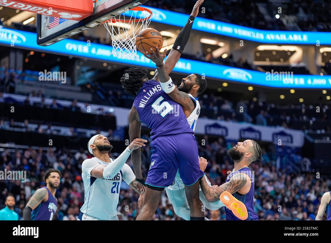 Dallas Mavericks guard Kyrie Irving (11) tries to shoot around ...