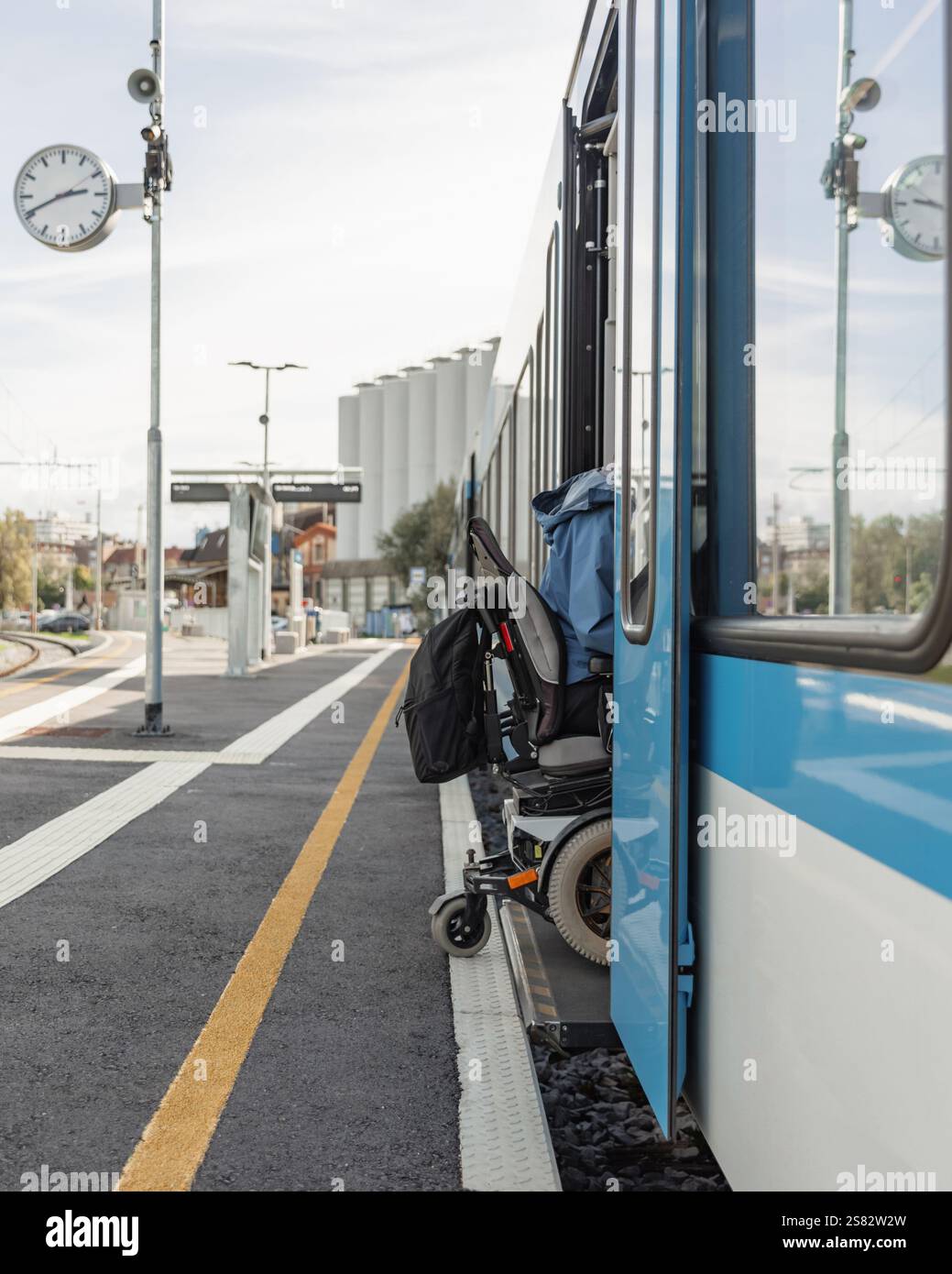 Man with disability on electric wheelchair entering a train. Accessible ...