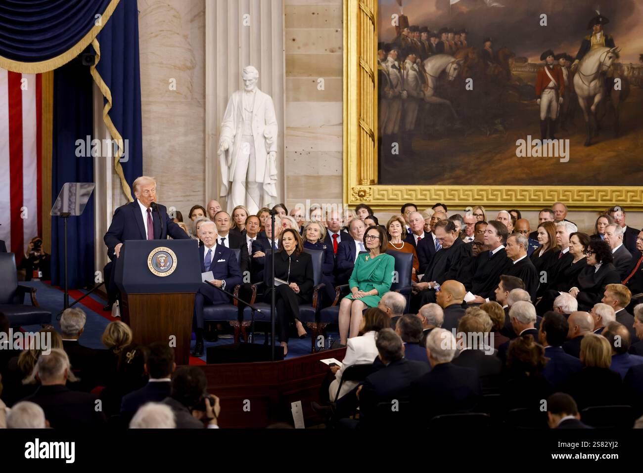US President Donald Trump (L) delivers remarks after being sworn in as ...
