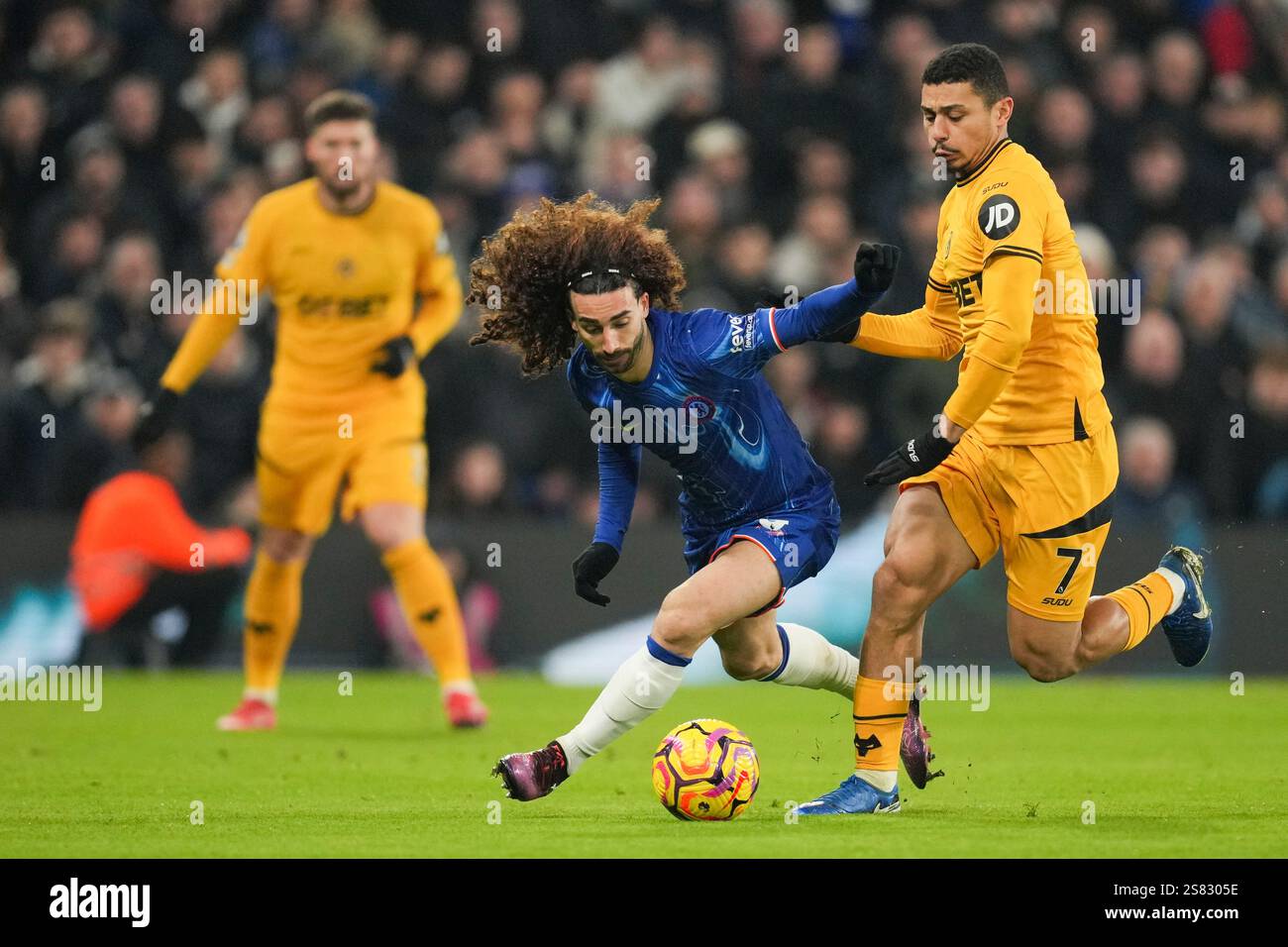 Chelsea's Marc Cucurella, center, duels for the ball with Wolverhampton ...