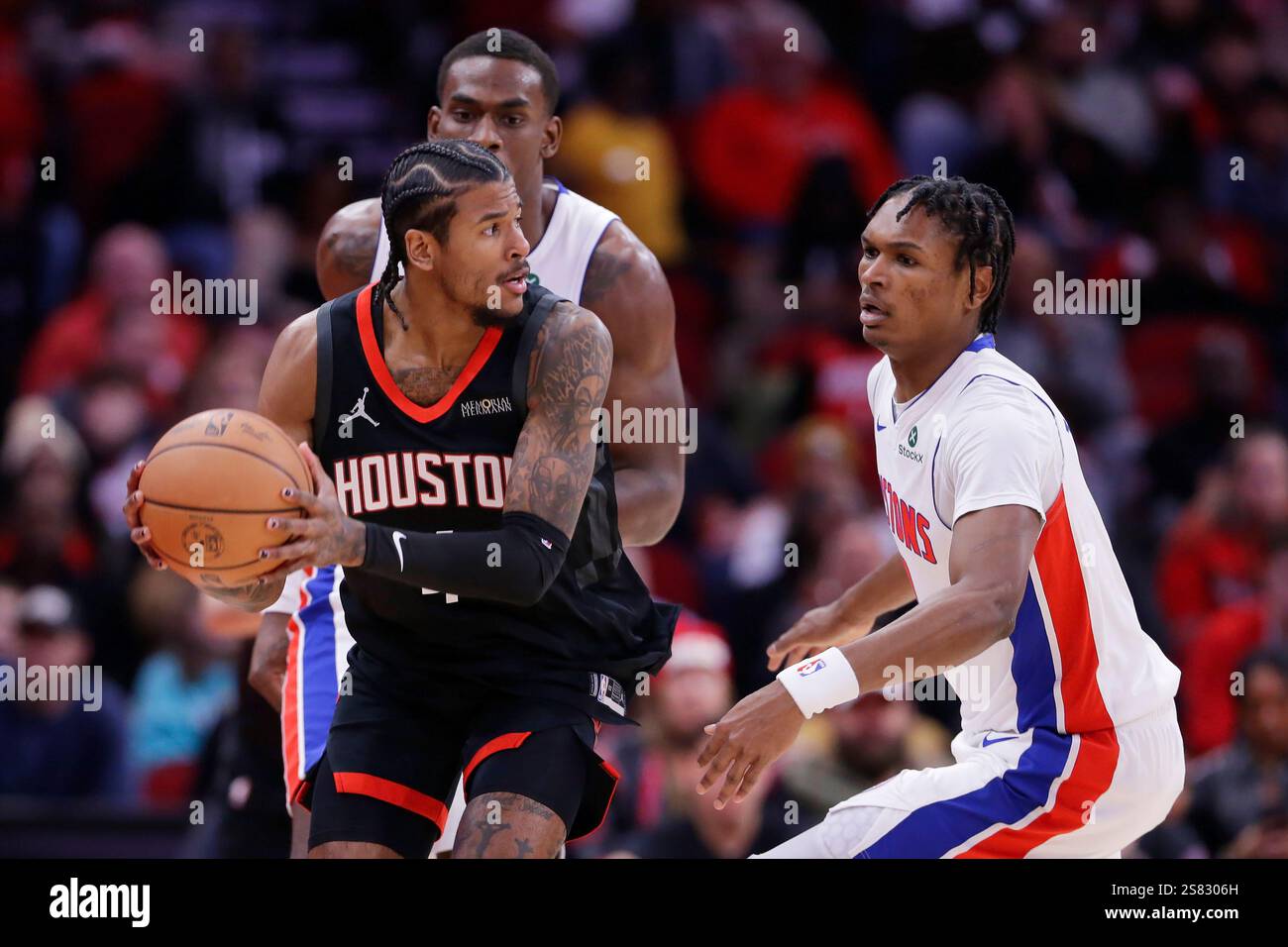 Houston Rockets guard Jalen Green, left, looks to pass the ball under ...