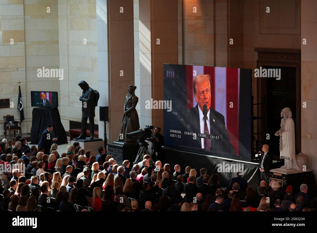 President Donald Trump is seen on screen in Emancipation Hall as he ...