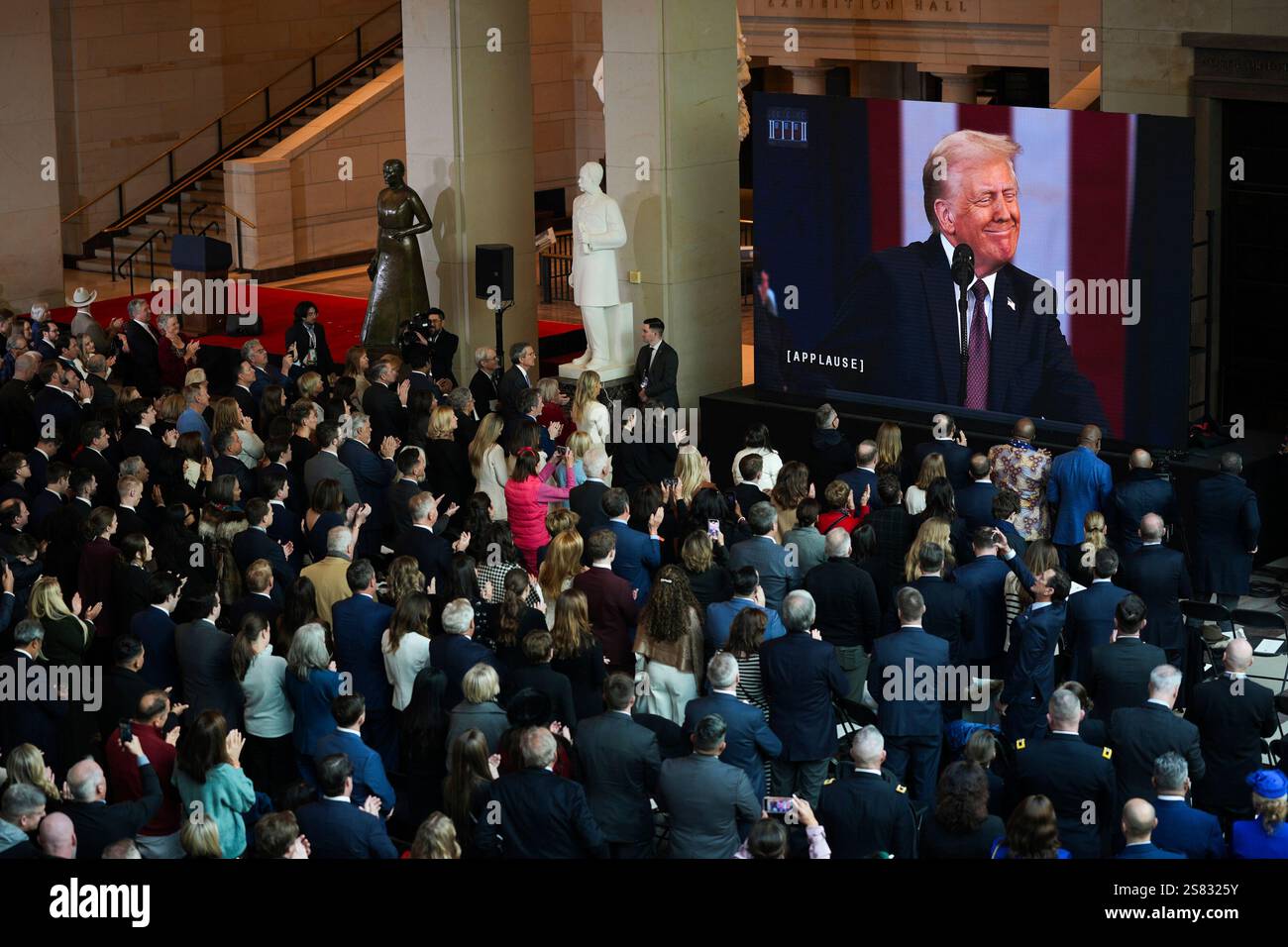 President Donald Trump is seen on screen in Emancipation Hall as he ...