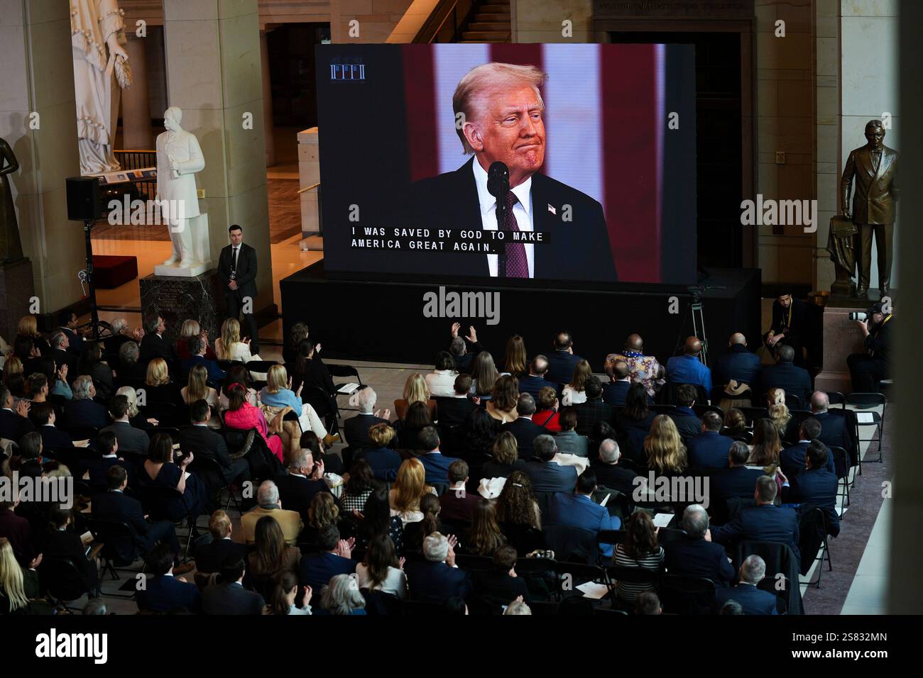 President Donald Trump is seen on screen in Emancipation Hall as he delivers his inaugural ...