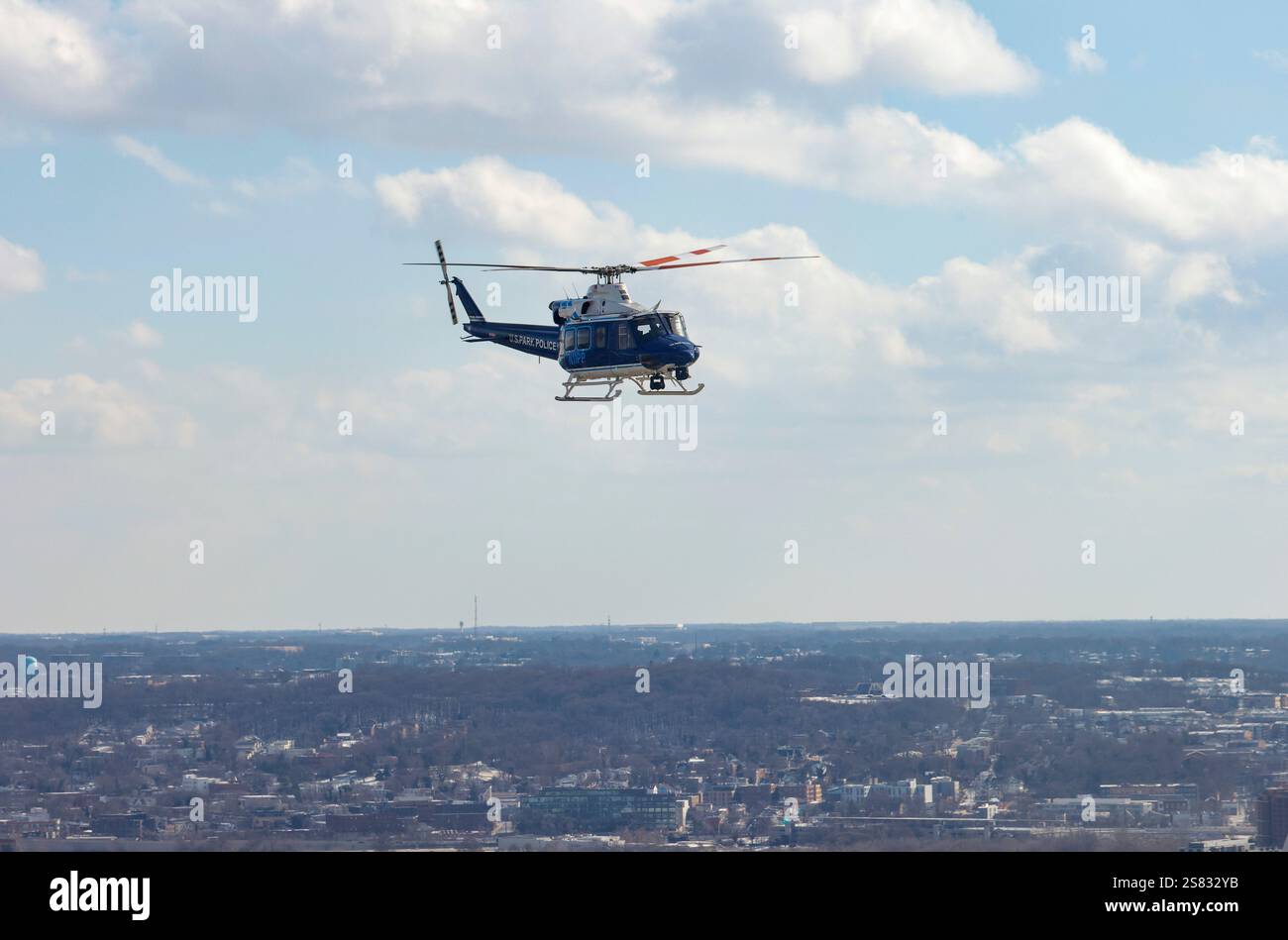A helicopter flies as seen from the top of the Washington Monument on ...