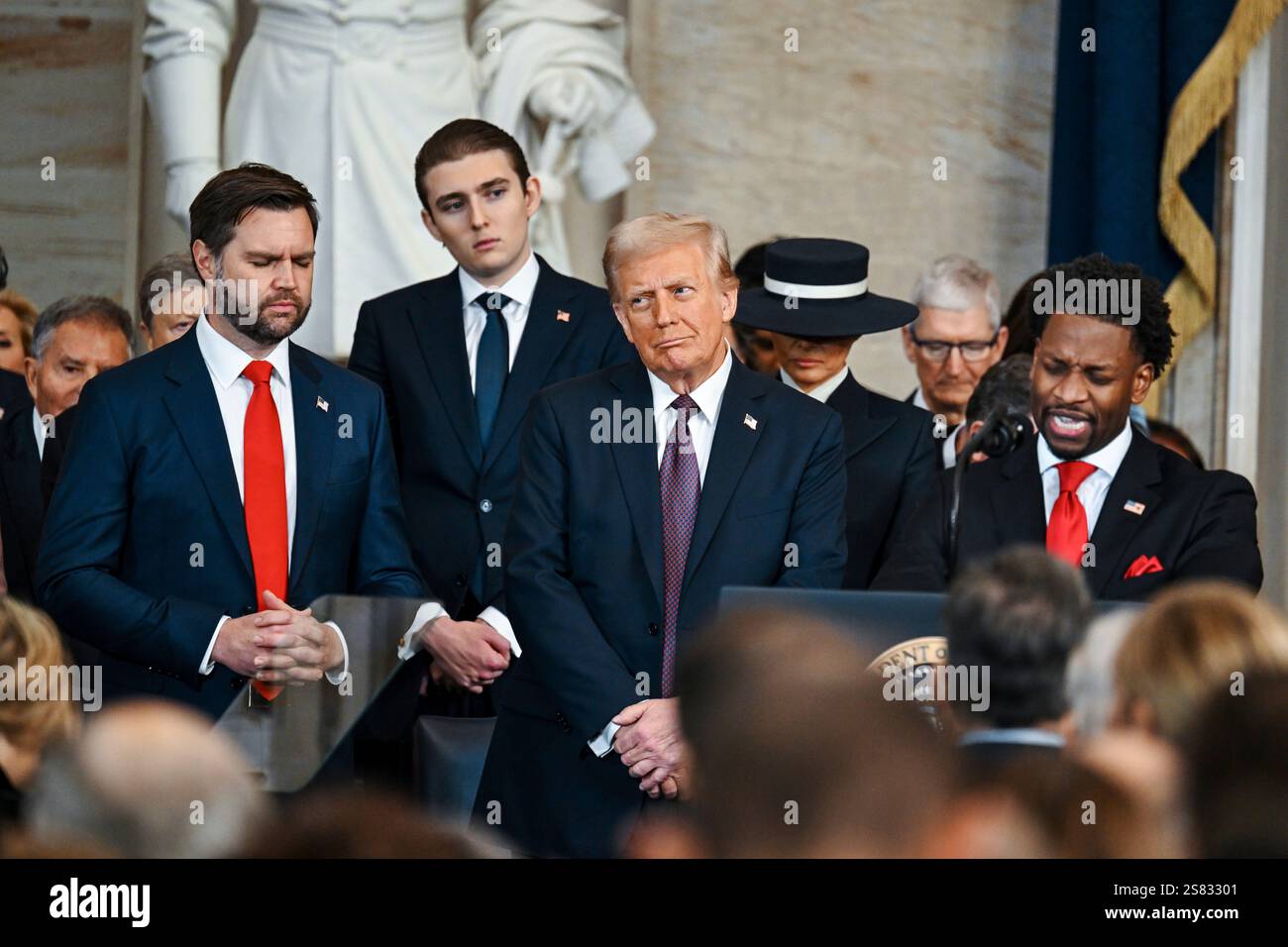 Vice President JD Vance, Barron Trump and President Donald Trump listen ...