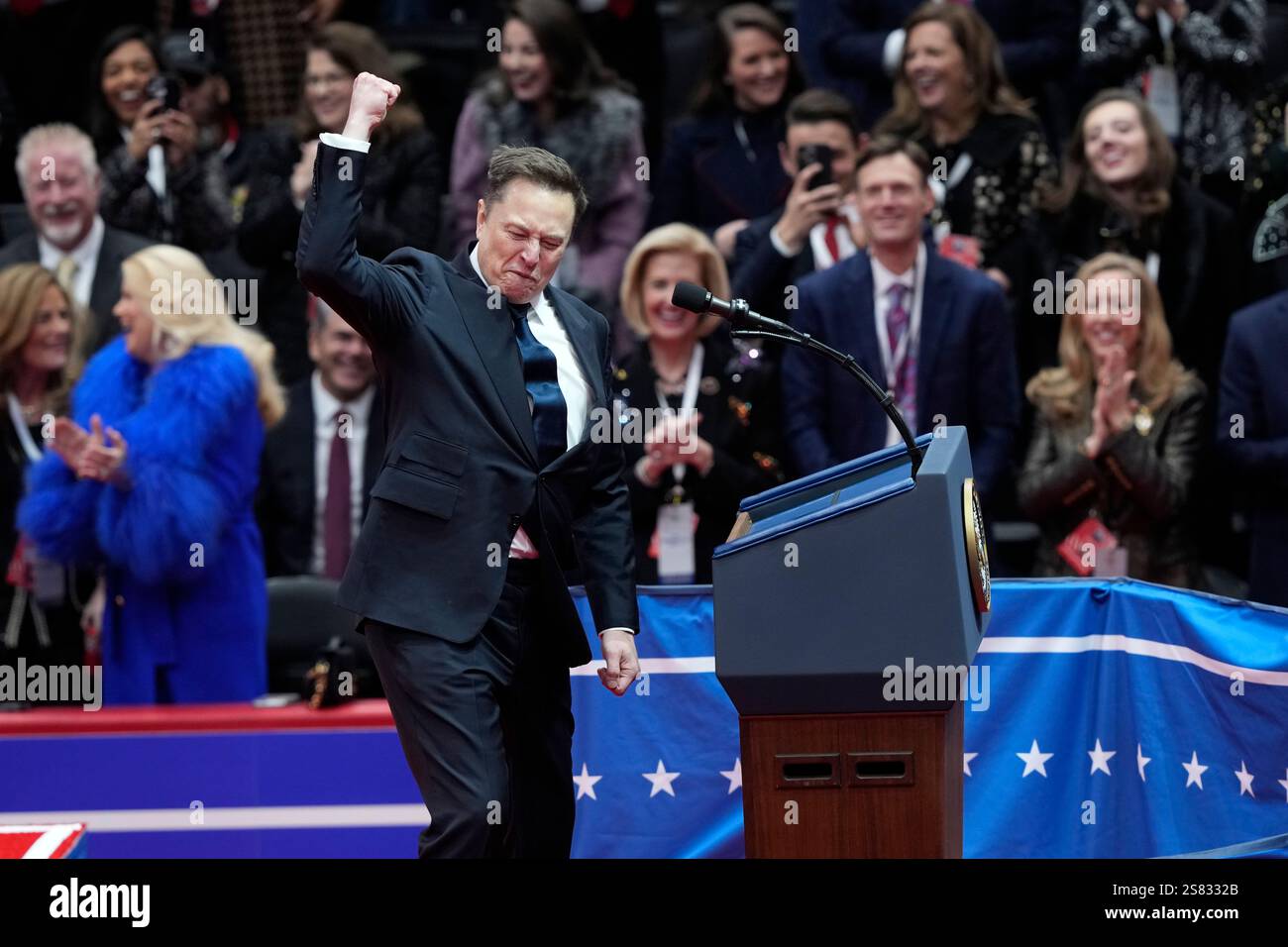 Elon Musk pretends to plant the American flag on Mars as he speaks at ...