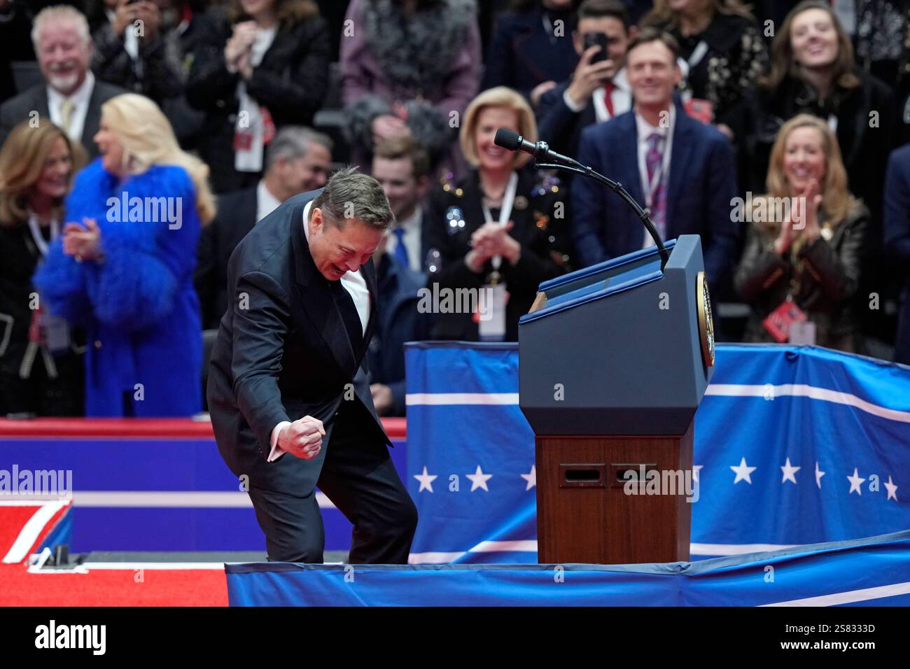 Elon Musk pretends to plant the American flag on Mars as he speaks at ...