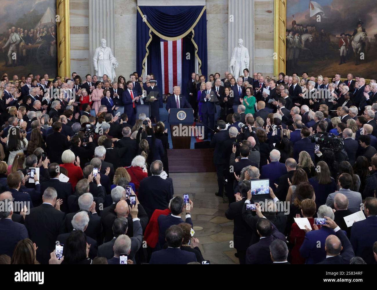 Attendees applaud U.S. President Donald Trump on the day of his ...