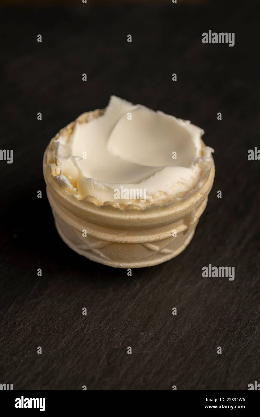 cups with buttercream during dessert cooking, cream filled cups made of ...