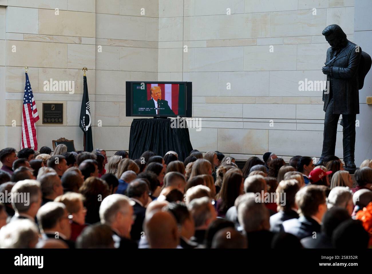 Washington, DC, USA. 20th Jan, 2025. Guests watch as US President Donald Trump, on screen ...