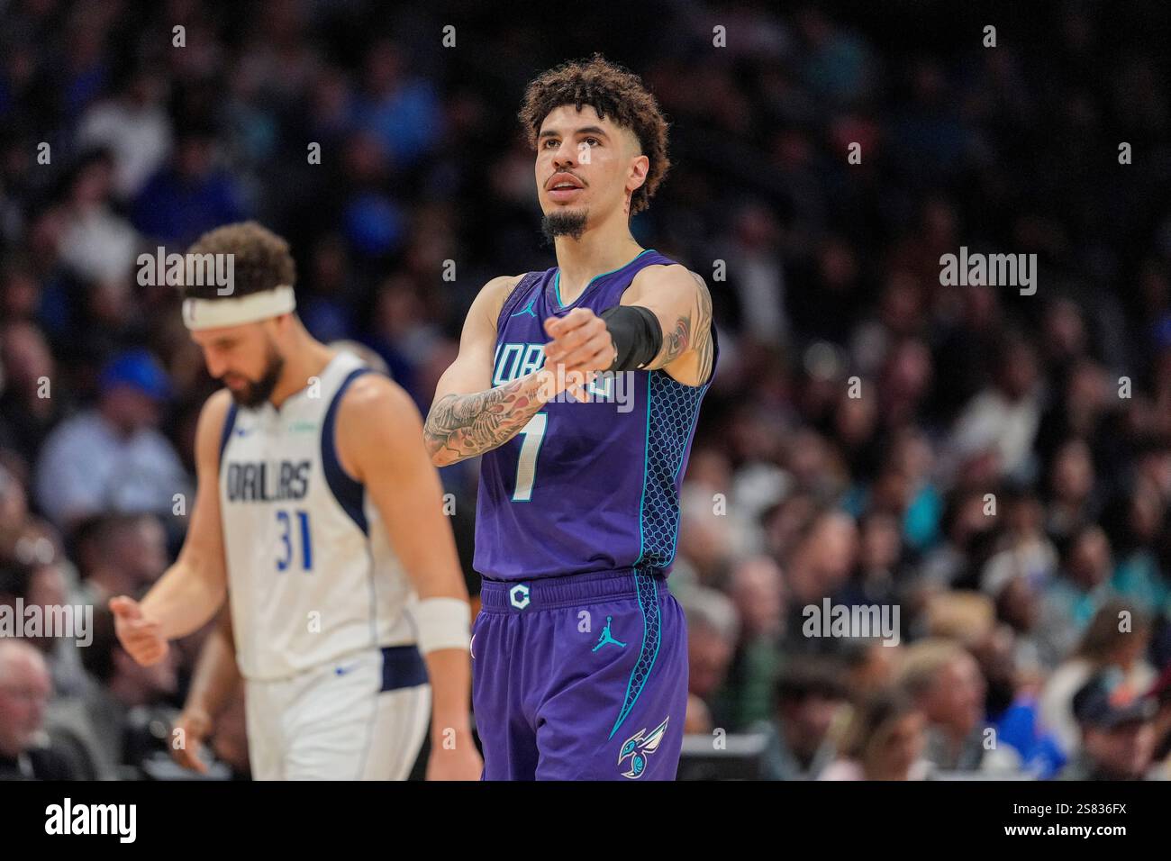 Charlotte Hornets guard LaMelo Ball (1) adjusts his arm band during the ...