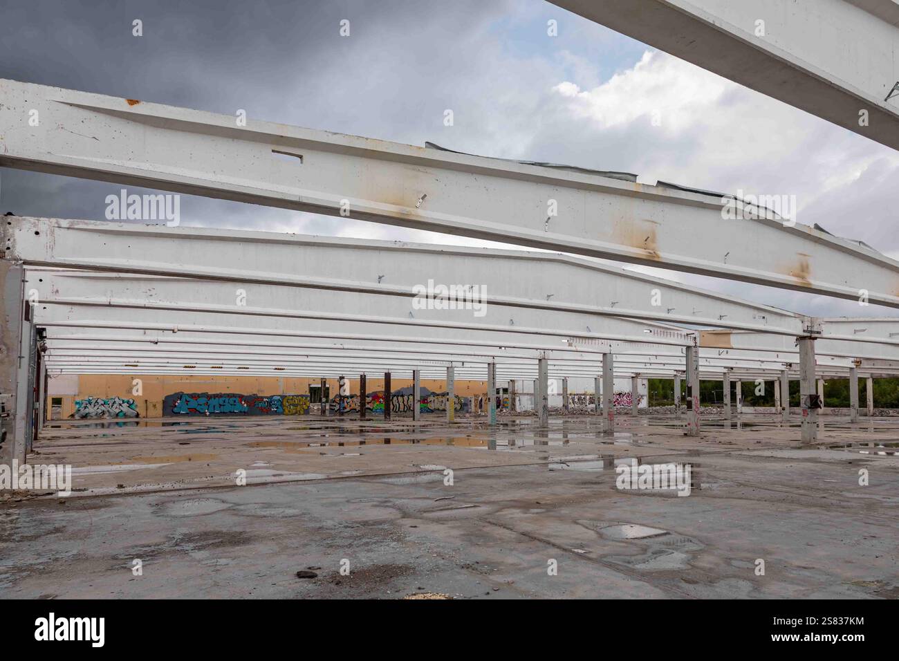 Exposed concrete beams of an abandoned and partially demolished factory ...